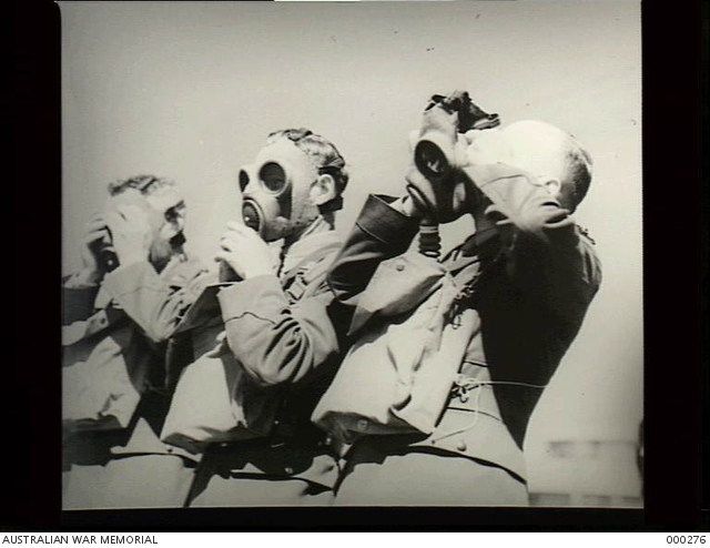 Soldiers in training demonstrating the fitting and wearing of gas masks ...