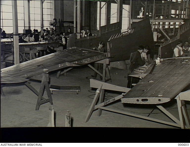 At the Commonwealth Aircraft Corporation Factory, men working in a ...