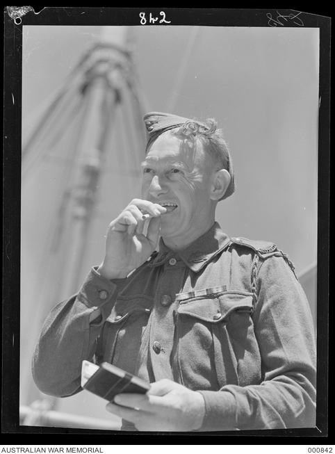 ON BOARD SHIP - A DIGGER HAS A CIGARETTE ON DECK. PTE. THOMAS LALOR ...