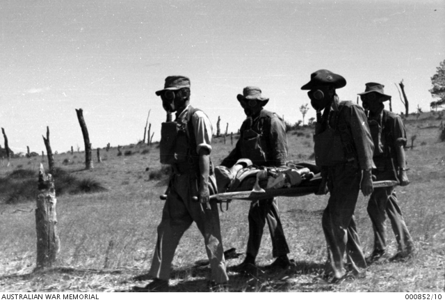 Four members of the Army Medical Corps (AMC) members wearing gas masks ...