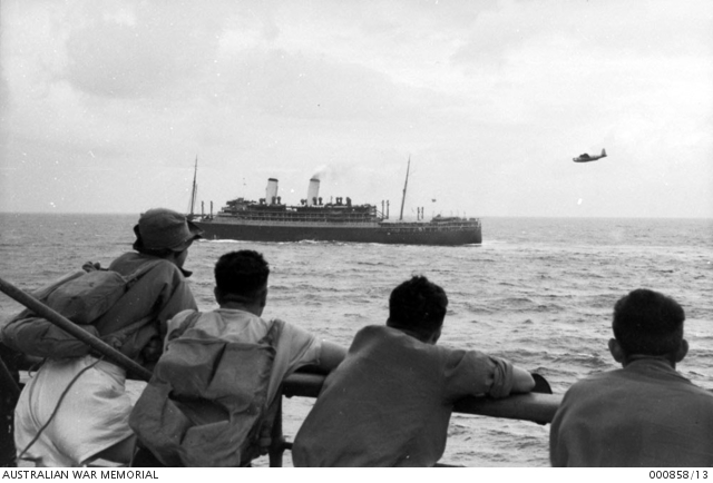 A group of soldiers of the 6th Division AIF watch from their troop ...