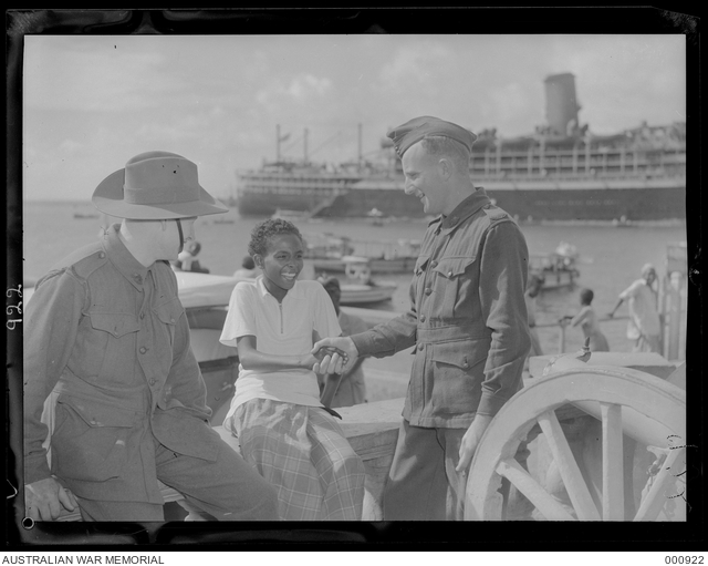AT ADEN - TWO OF OUR LADS MAKE FRIENDS WITH A RATHER SHY NATIVE LAD ...