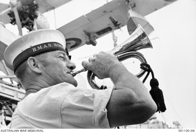 The bugler of the modified Leander Class cruiser HMAS Hobart sounding a ...