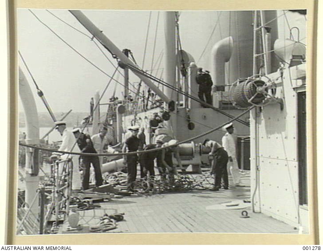 A 6 inch gun being swung aboard the Armed Merchant Cruiser HMAS ...