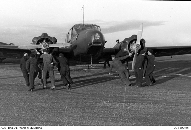 RAAF airmen pushing an Avro Anson aircraft out of a hangar onto the ...