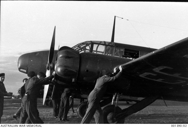 RAAF airmen pushing an Avro Anson aircraft out of a hangar onto the ...