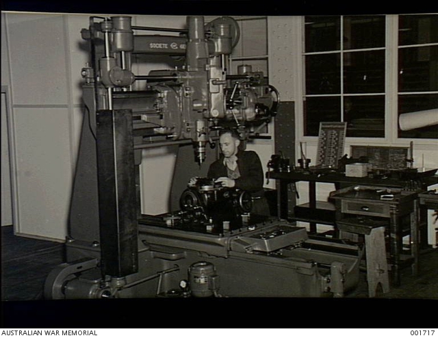 A male munitions employee at the Small Arms Factory, working in an ...
