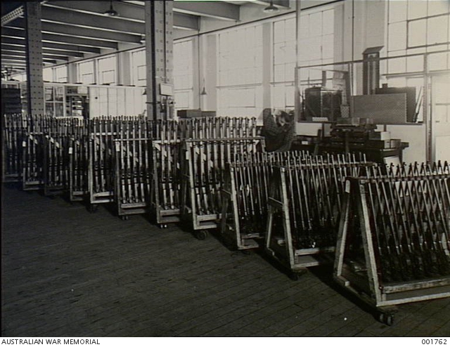 A munitions employee at the Small Arms Factory checking the movable ...