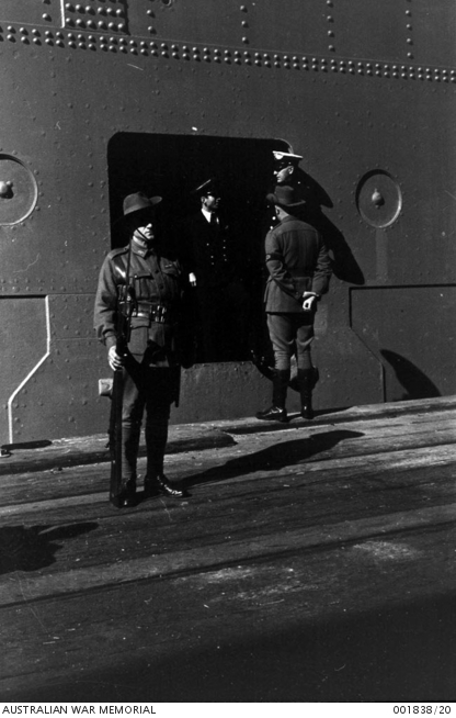 A soldier on guard duty with rifle and fixed bayonet at an entrance to ...