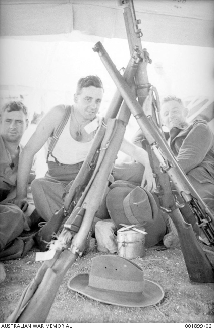 Members of the 2/8th (Victorian) Battalion shown behind their stacked ...