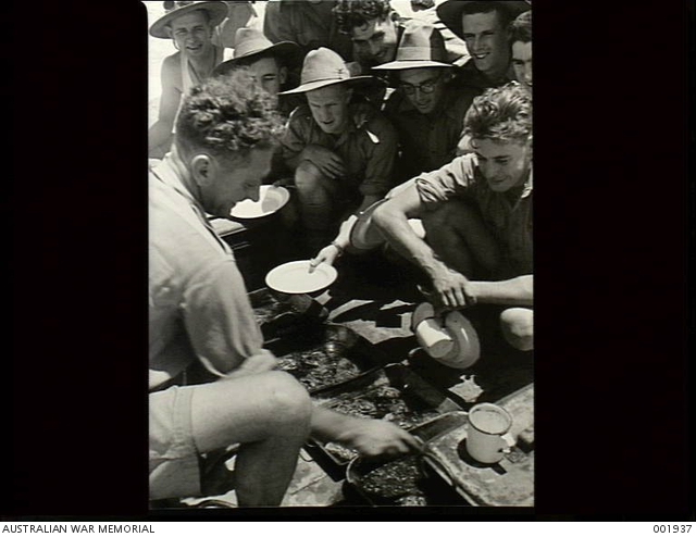 Biet Jerjla. Troops gather around the food waiting to be served at the ...