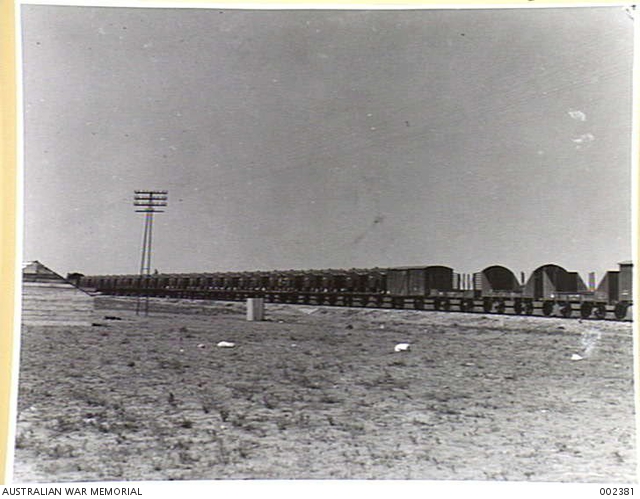 BEIT JERJIA. A TRAIN LOAD OF ARMOURED CARS PASSES THE CAMP ON ITS WAY ...