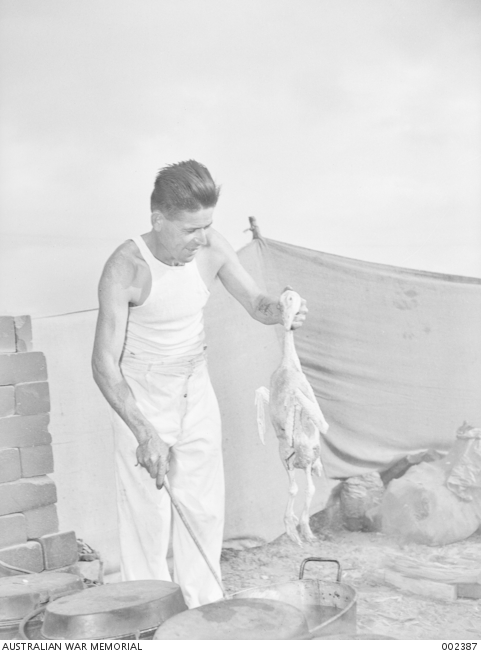 BEIT JERJIA - 17TH BDE INFANTRY. THE MAN'S COOK PTE. R. LE SUEY HOLDS ...