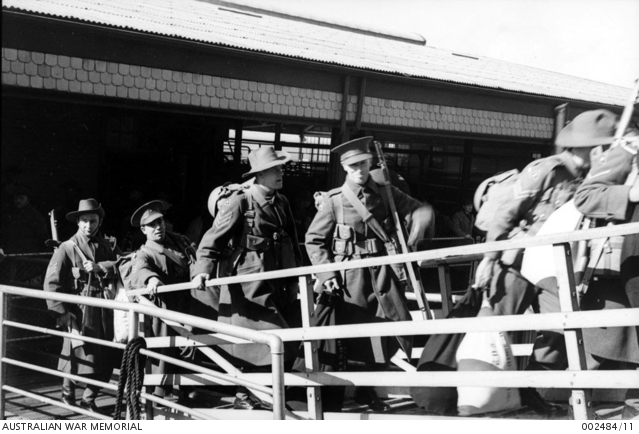 Members of the 6th Division move up the gangway for embarkation on the ...