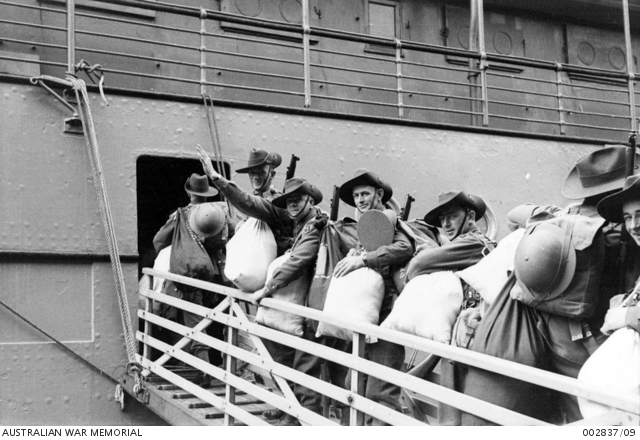Loaded with their gear, troops of a unit of the 6th Division move up ...