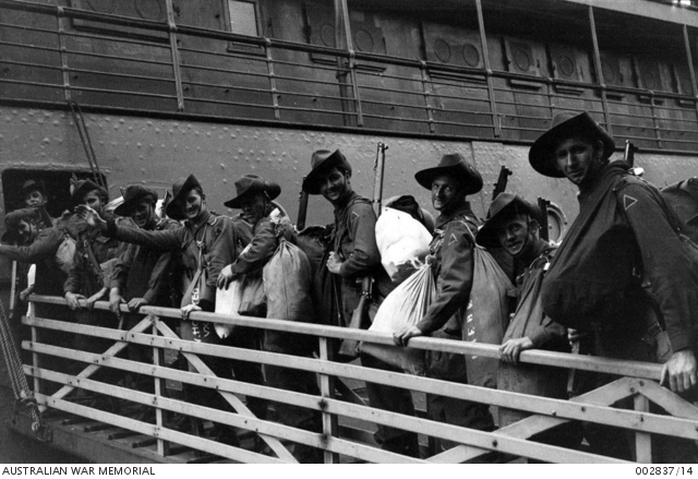 Loaded with their gear, troops of a unit of the 6th Division move up ...