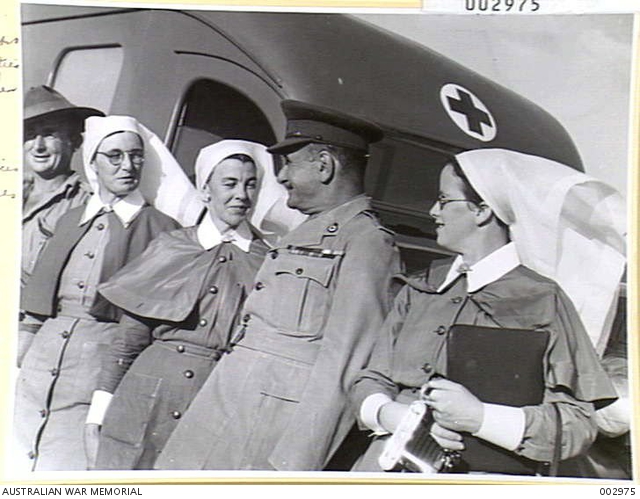 Red Cross Commissioner Colonel Cohen talks to three unidentified ...