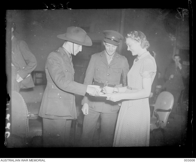 LT. T. MAYES (MELB) AND LT. N. HOWLETT (SYDNEY) BEING SERVED, WITH TEA ...