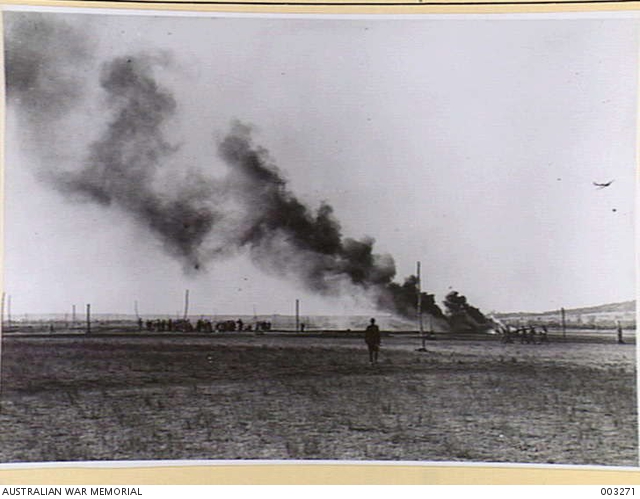 AN R.A.F. FIGHTER PLANE GIVE A VICTORY SWOOP OVER A DOWNED GERMAN ...