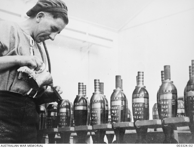 AT AN AUSTRALIAN EXPLOSIVE FACTORY. FILLING TRENCH MORTAR BOMBS WITH ...