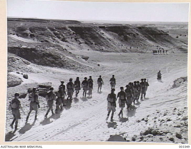 TROOPS ADVANCING THROUGH A NARROW DEFILE. | Australian War Memorial