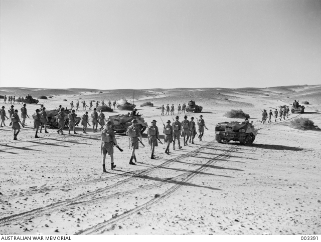 WESTERN DESERT. INFANTRY ADVANCE DURING A TRAINING EXERCISE UNDER COVER ...