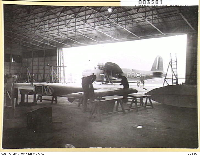 VIEW OF A HANGAR SHOWING A 10 SQUADRON RAAF SUNDERLAND ON THE TARMAC ...
