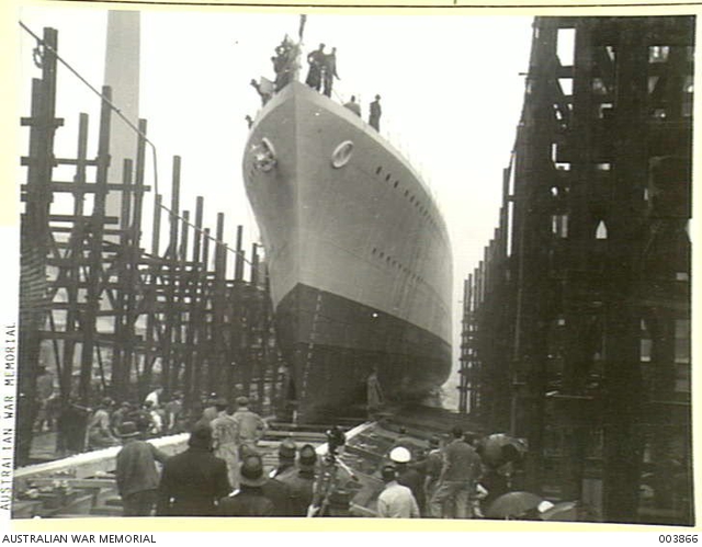 CROWDS CHEER AS THE ARUNTA MOVES DOWN THE SLIPS. | Australian War Memorial