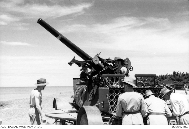 Members of an Australian Army Anti-Aircraft Unit gather around a 3 inch ...