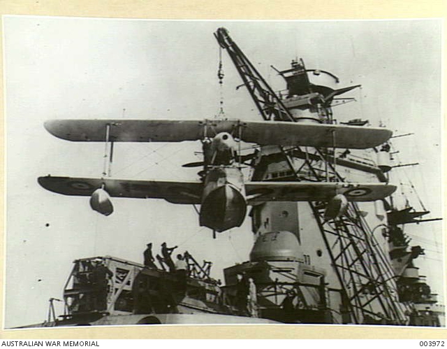A SUPERMARINE WALRUS AMPHIBIAN AIRCRAFT BEING HOISTED ON TO THE ...