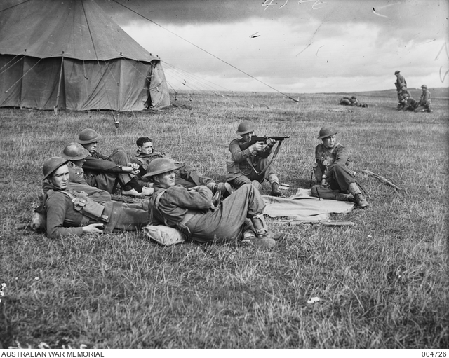 THE CLASS LEARNS THE WORKING OF A NEW AUTO RIFLE. | Australian War Memorial