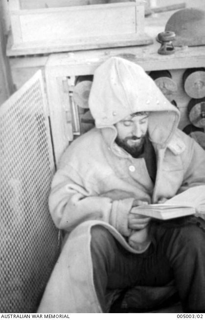 An unidentified sailor aboard HMS Ladybird has a quiet read during a ...