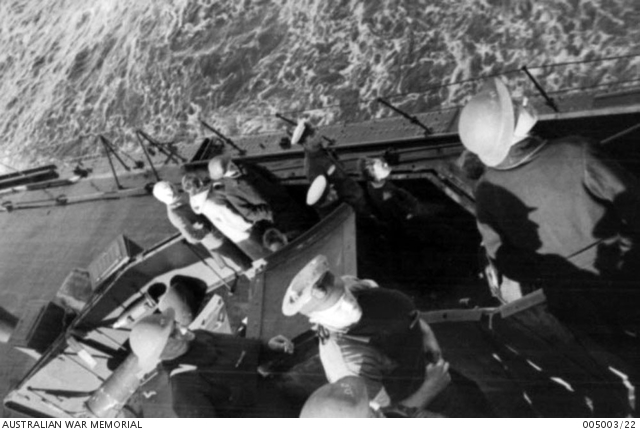 Some of the crew of HMS Ladybird gather for a brief rest during a lull ...
