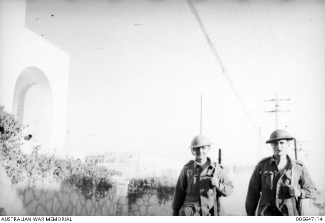 Australian troops walking through the streets of Derna after its ...