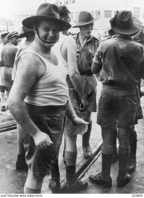 A group of Australian troops of the 8th Division on the wharf at ...