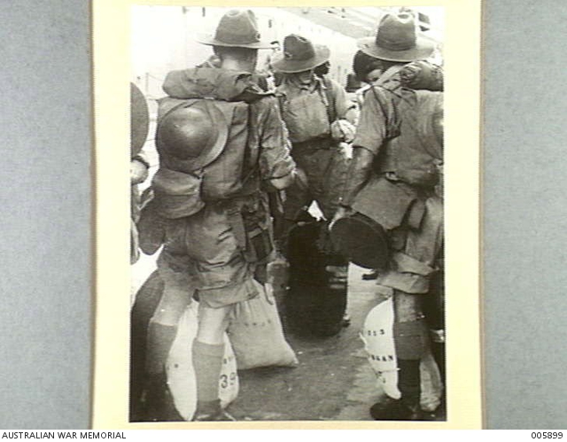 A group of soldiers of the 8th Division on the wharf after the voyage ...
