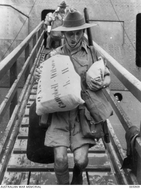 A soldier of 22nd Brigade, 8th Division, disembarking from the troop ...