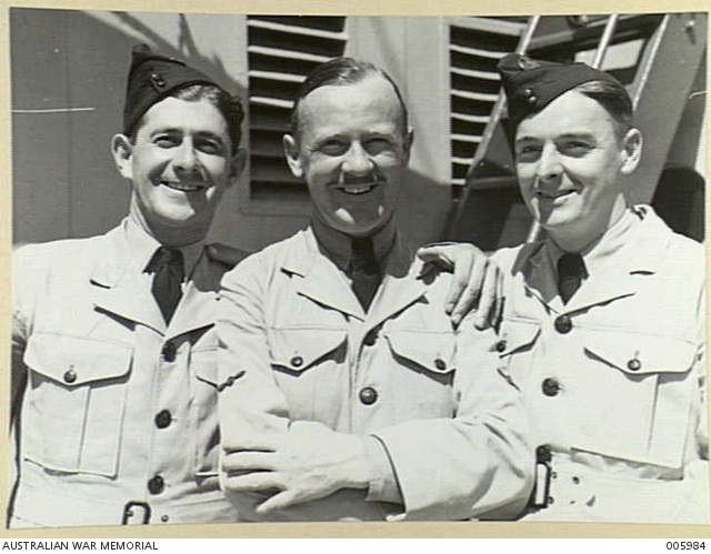 Group portrait of three RAAF personnel bound for Canada on board ...