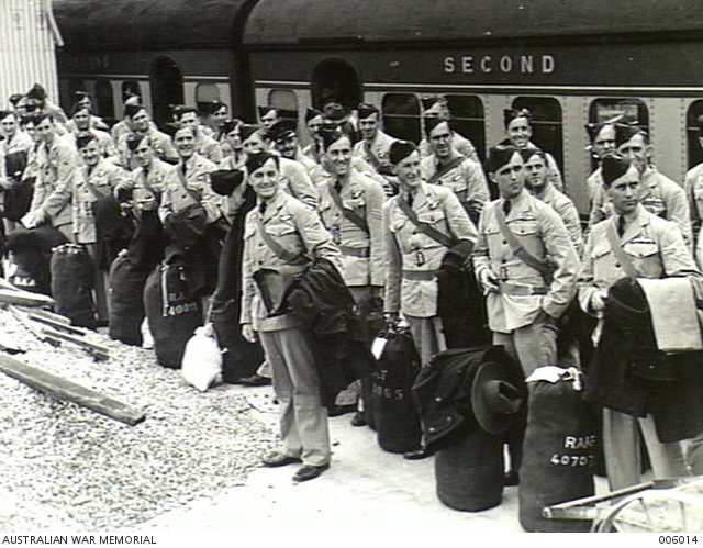 A group of RAAF aircrew assembled on the platform after detraining and ...