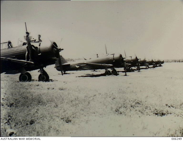 Darwin. Members of No. 12 Squadron RAAF, checking and cleaning Wirraway ...