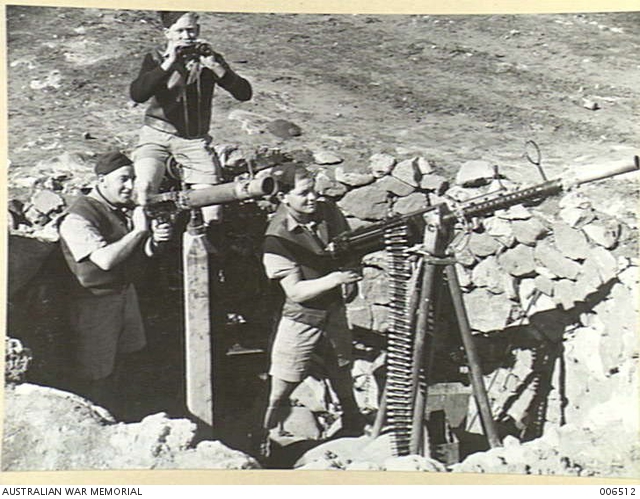 BENINA. T. CLOVER, B. LEAVY AND P. BRUCE WITH A BREDA .5 ANTI AIRCRAFT ...