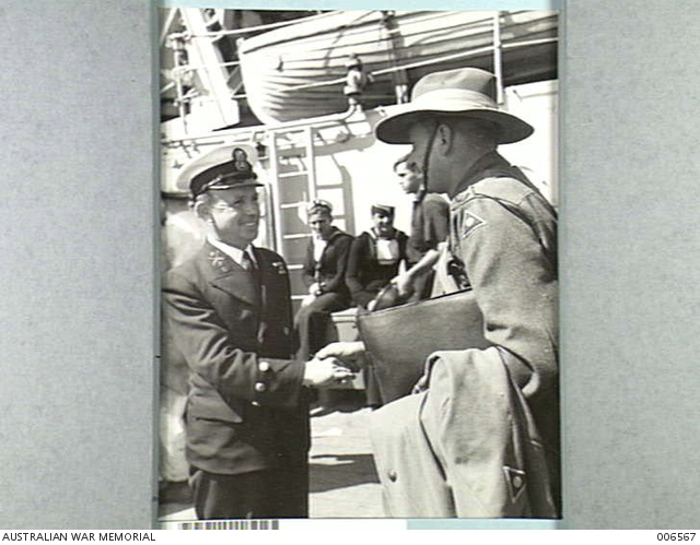 AUSSIE MEETS AUSSIE. A CREW MEMBER OF HMAS PERTH GREETS A DIGGER ...
