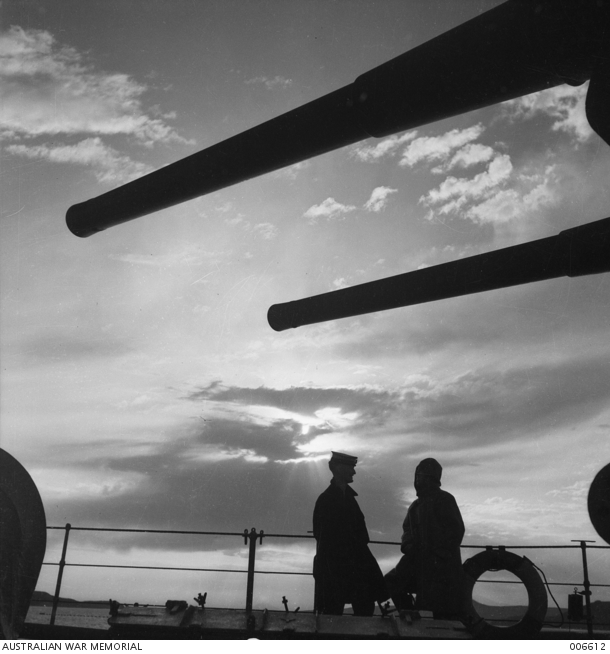 TWO CREW MEMBERS OF HMAS PERTH ARE SILHOUETTED AGAINST THE SKY AS THEY ...