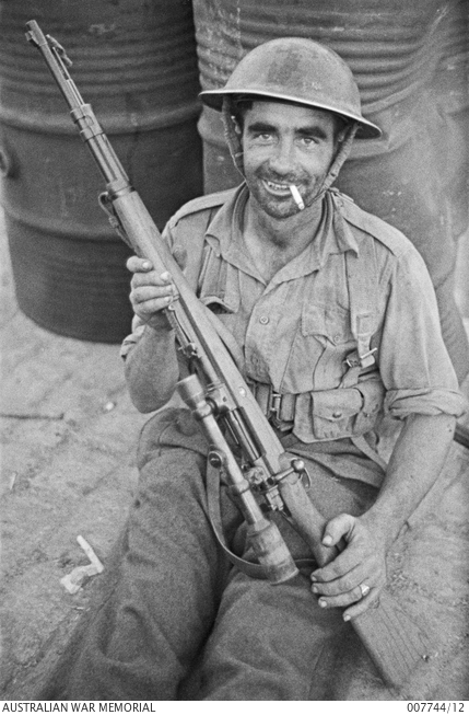 A smiling soldier from the 6th Division enjoys a cigarette after being ...