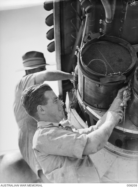 LYDDA, SYRIA. RAAF MECHANICS AT WORK ON AN AMERICAN TOMAHAWK AIRCRAFT ...