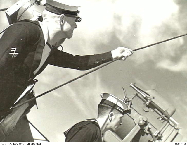 H.M.A.S. DOOMBA. HOISTING SIGNAL FLAG ALOFT. | Australian War Memorial