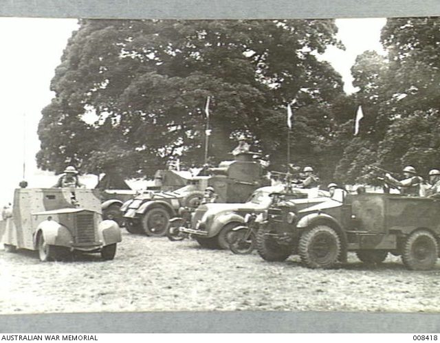 AN ARMOURED CAR PASSING A SELECTION OF PARACHUTIST CHASERS SEEN AT THE ...