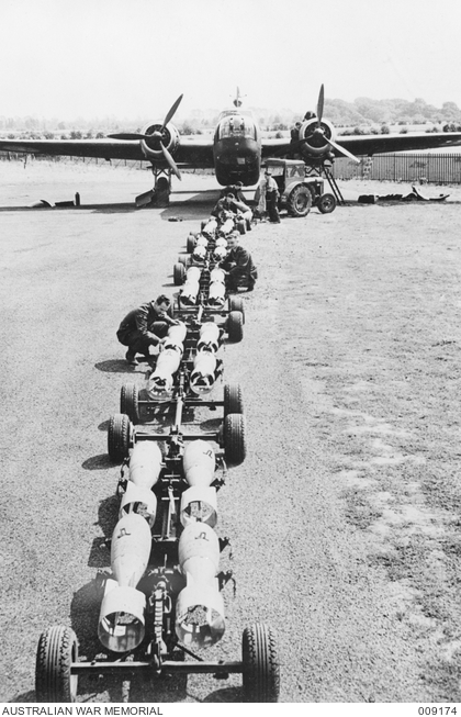 WITH THE R.A.F. IN ENGLAND. LOADING HIGH EXPLOSIVE BOMBS ONTO A ...