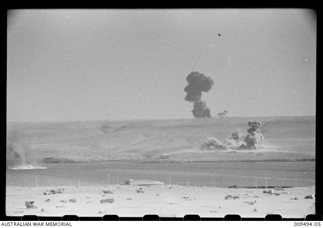 TOBRUK. BOMBS FROM DIVE BOMBERS BURSTING ON HARBOUR FORESHORE ...
