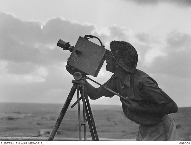 Damien Parer, a Department of Information photographer, filming with a ...